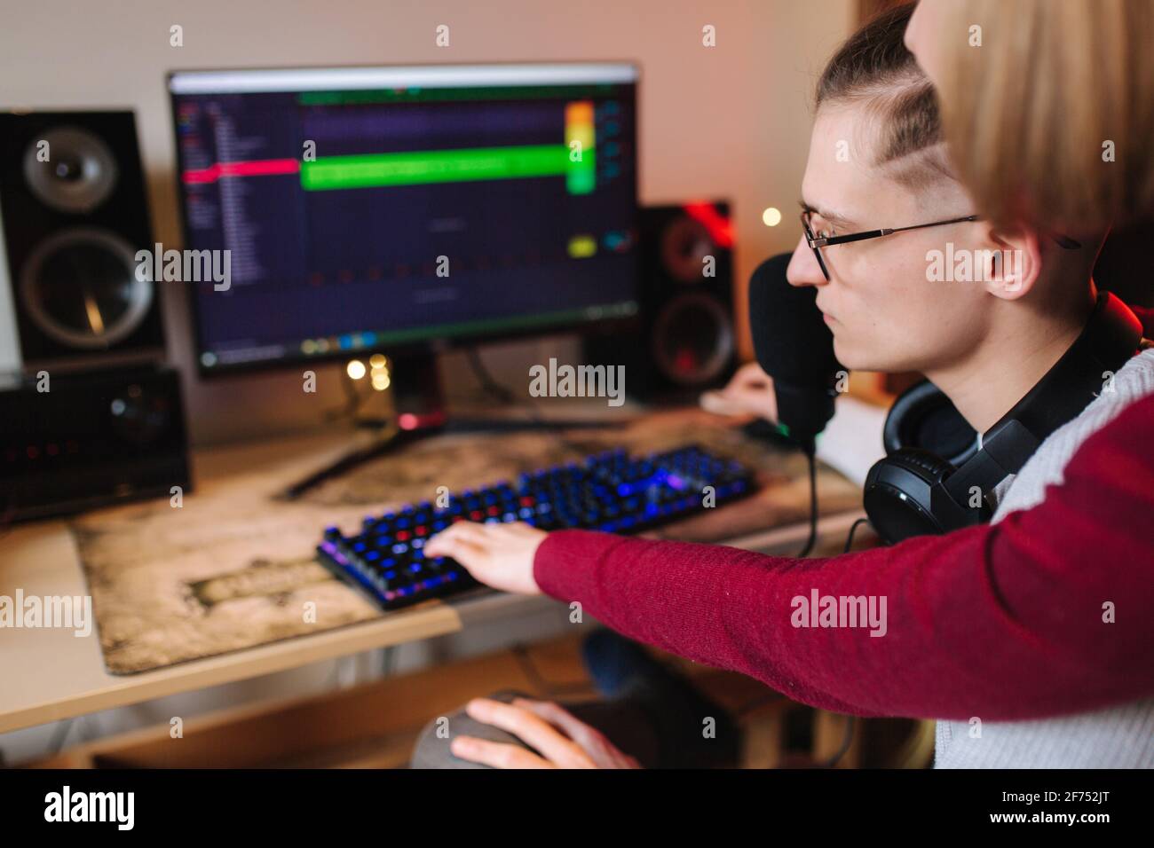 Woman put finger on keyboard and help for man in his work. Process of ...