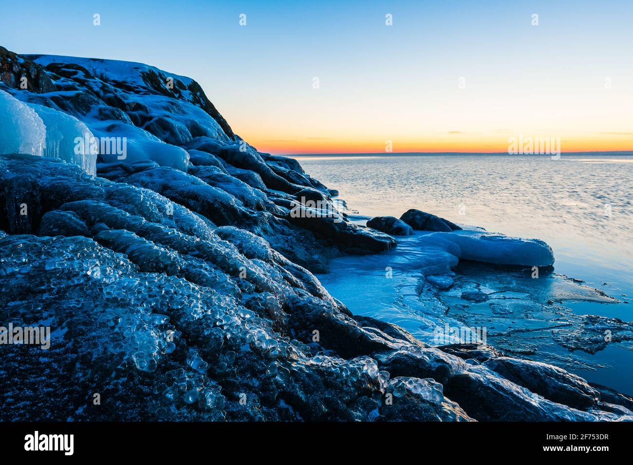 Sunset at icy coastal scene Stock Photo - Alamy