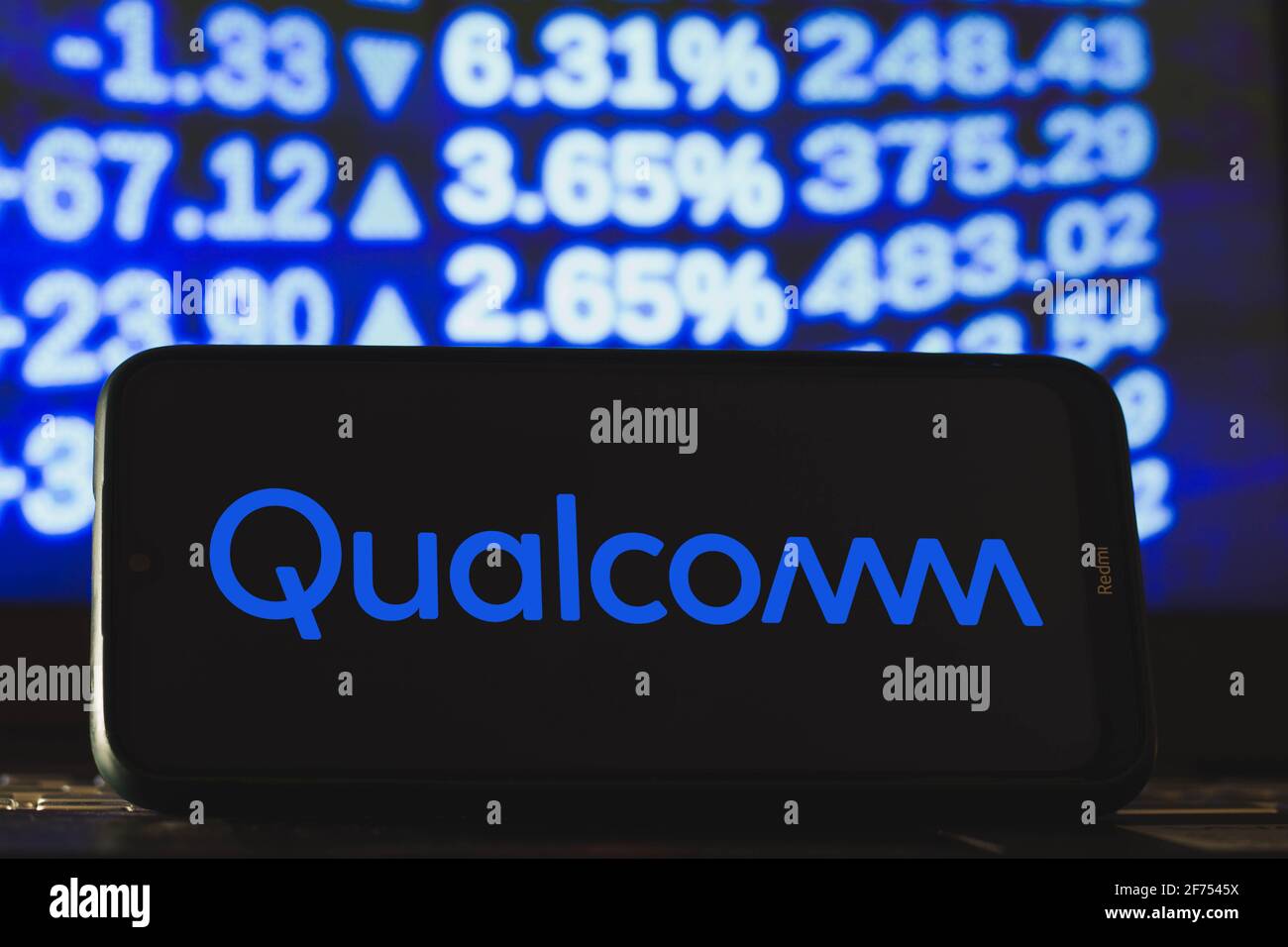 In this photo illustration a Qualcomm logo seen displayed on a ...