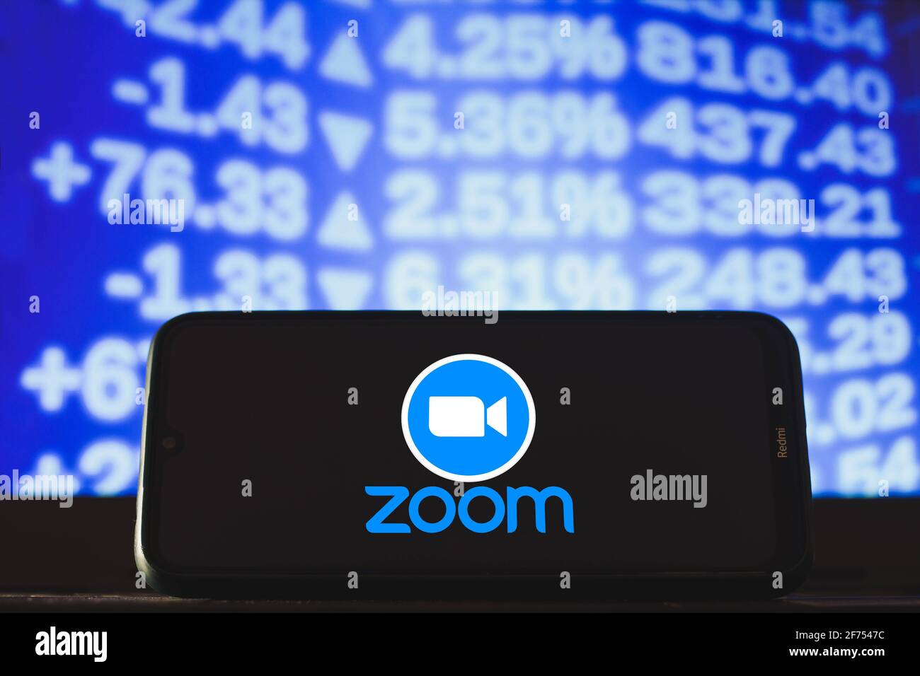 In this photo illustration a Zoom logo seen displayed on a smartphone ...
