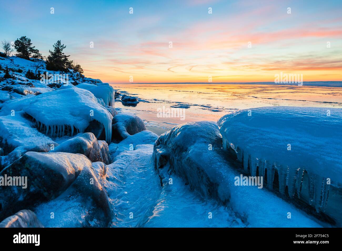 Sunset at icy coastal scene Stock Photo - Alamy