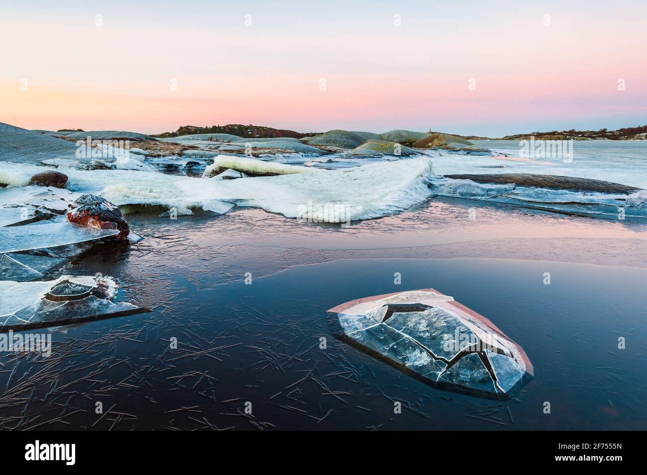Crack in ice at coastal scene during sunrise Stock Photo - Alamy