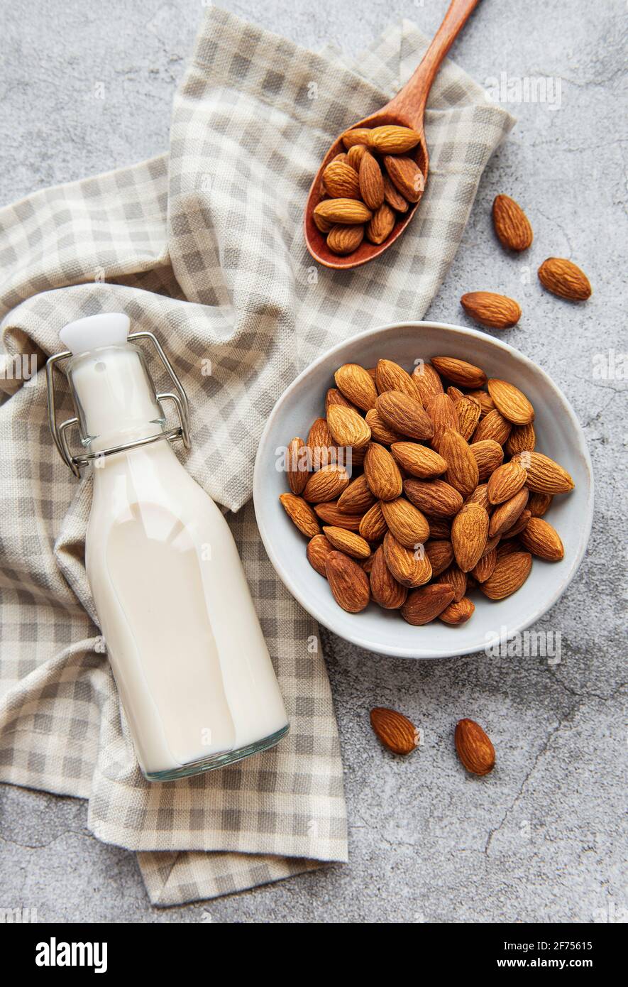 Glass bottle with almond milk and almonds on the table Stock Photo - Alamy