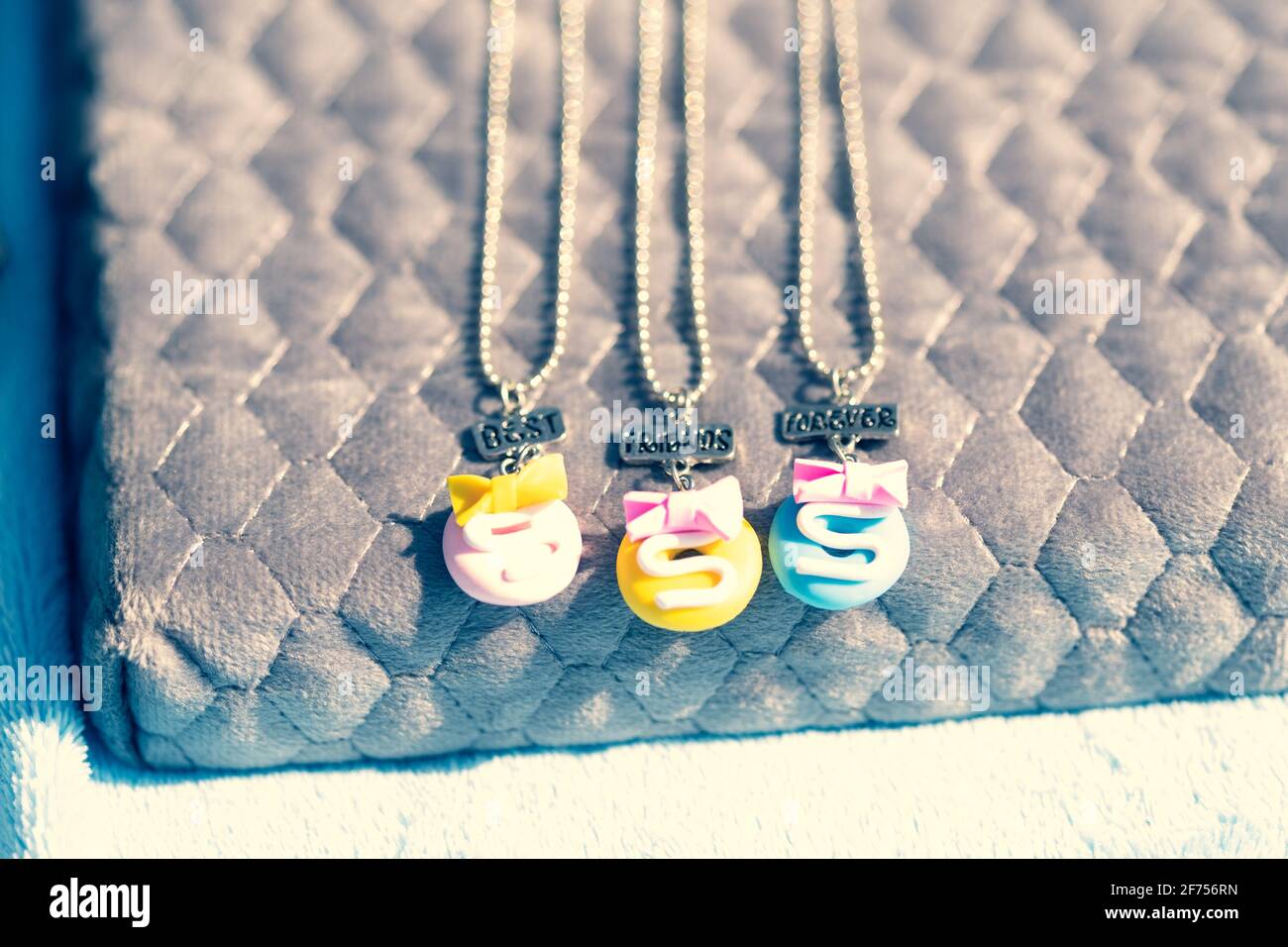 Three colored pendants best friends necklace shoot outside in a summer ...