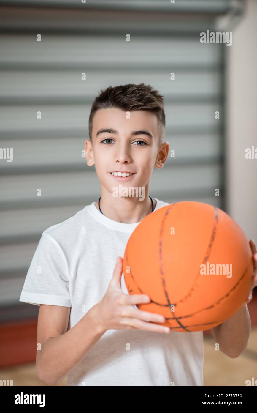 A cute boy with a ball looking contented Stock Photo - Alamy