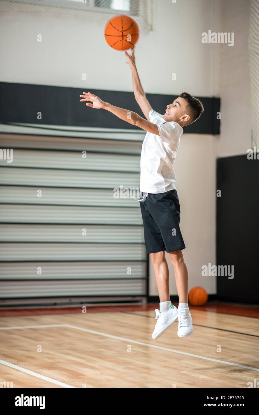 A cute boy with a ball feeling good and contented Stock Photo - Alamy