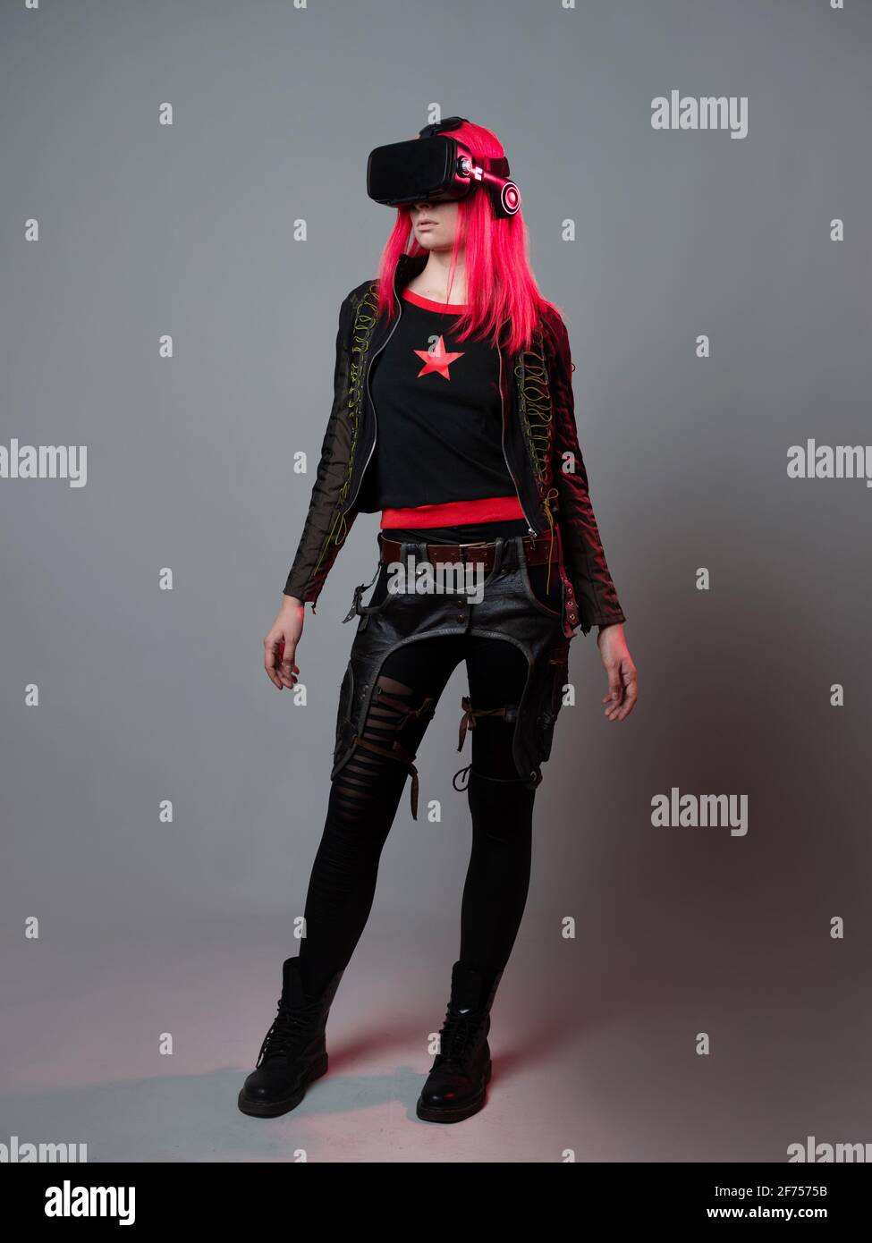 Games and virtual reality, a young red-haired woman uses a VR helmet ...