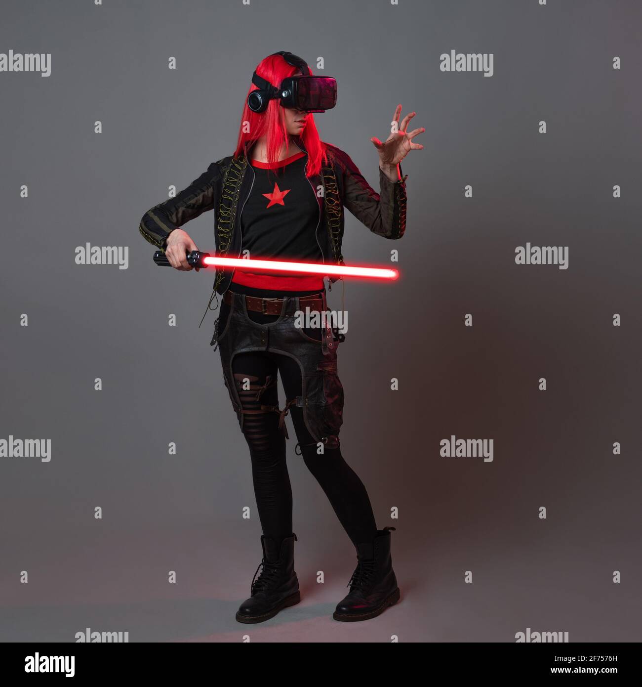 Games and virtual reality, a young red-haired woman uses a VR helmet ...