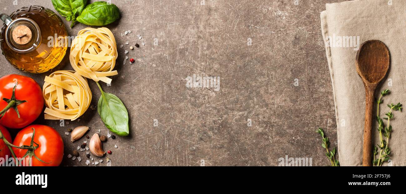 Cooking background with pasta, oil, tomatoes and spices Stock Photo - Alamy