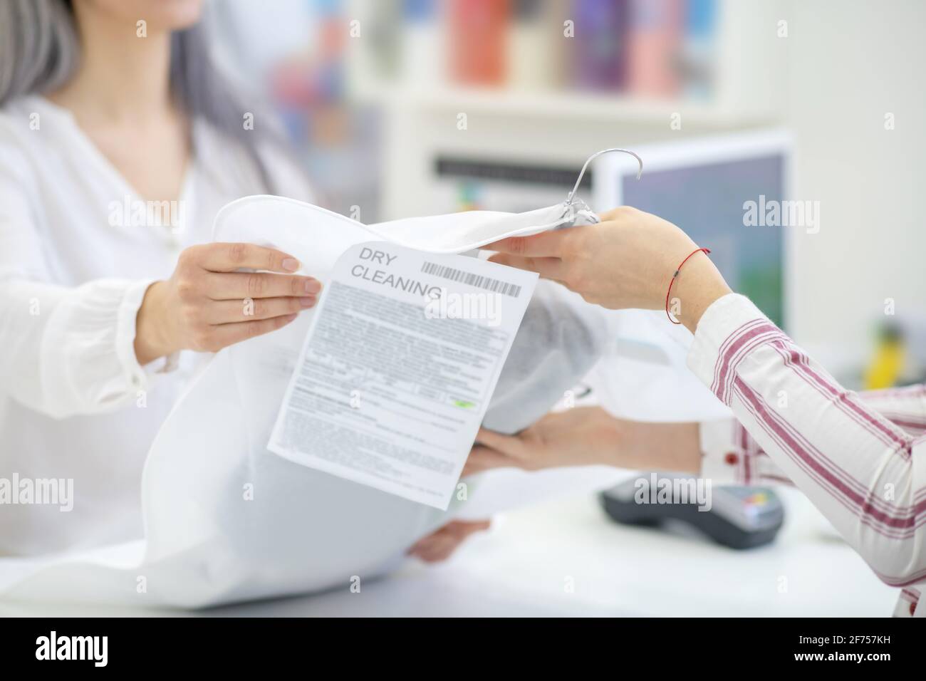 Hands of client and seller at time of order transfer Stock Photo - Alamy