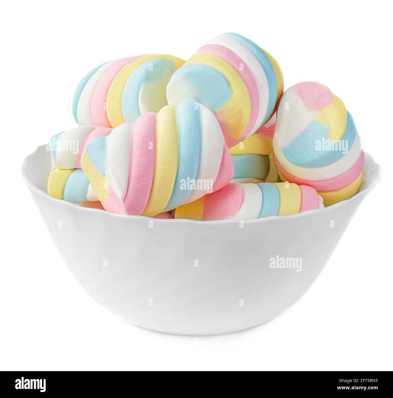 Marshmellow candies in a white bowl isolated on white background ...