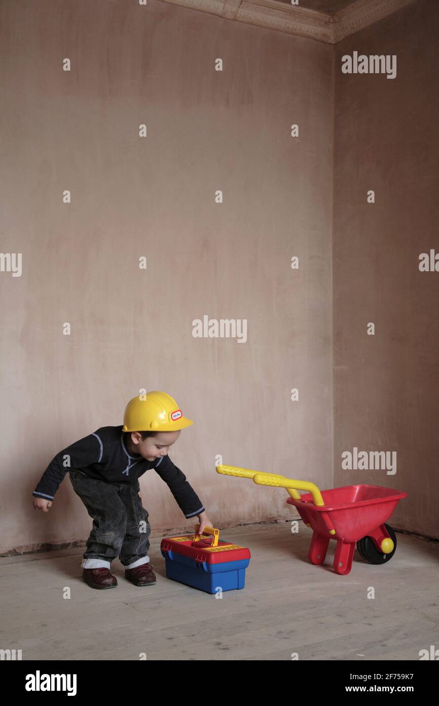 Toddler pretending to be a builder Stock Photo - Alamy