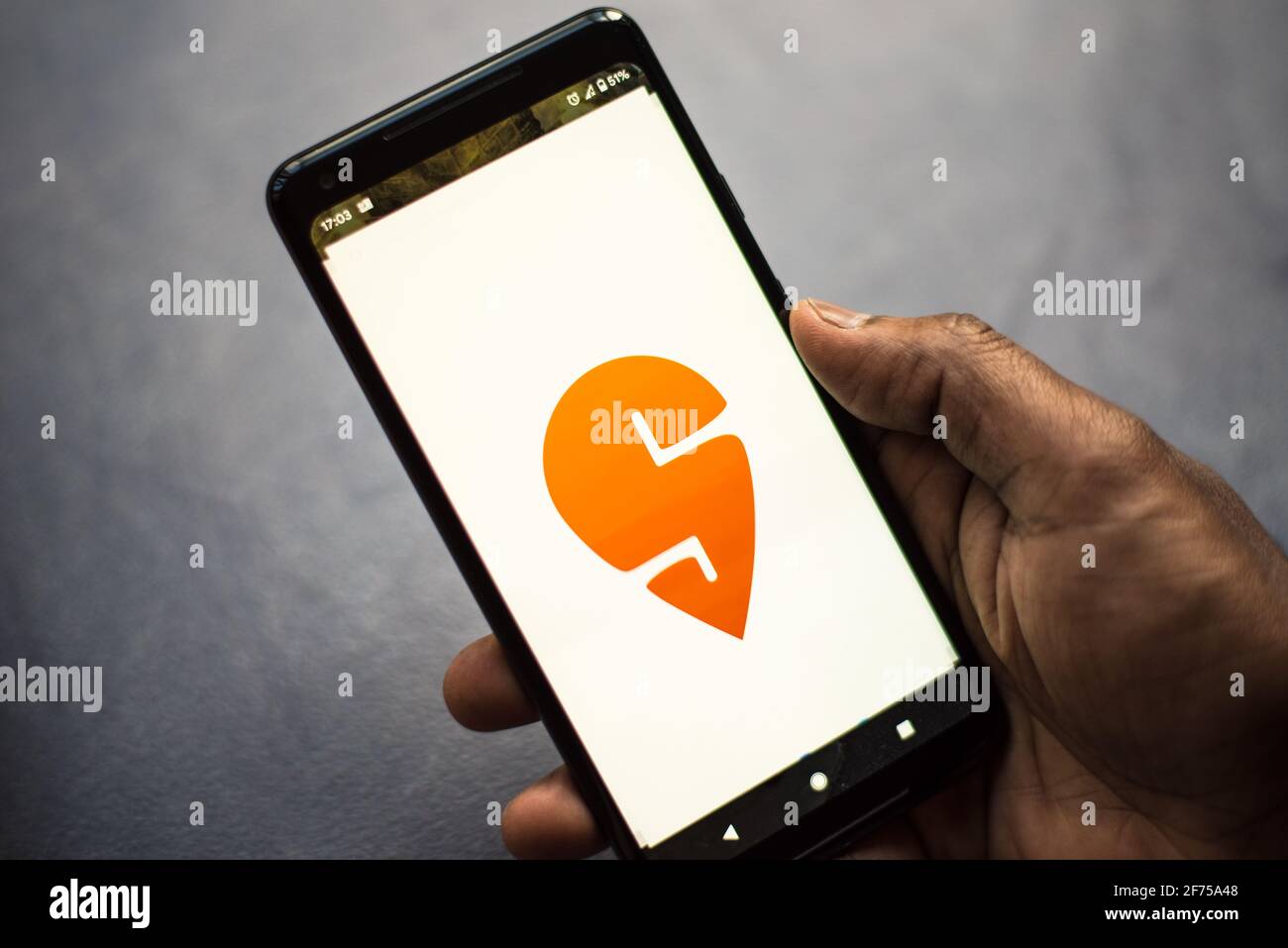 Swiggy food delivery app on smartphone held by an asian man Stock Photo ...