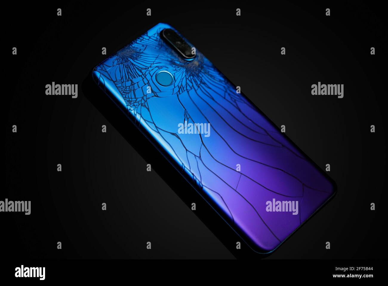 The back side of a broken phone. Spoiled smartphone camera Stock Photo ...