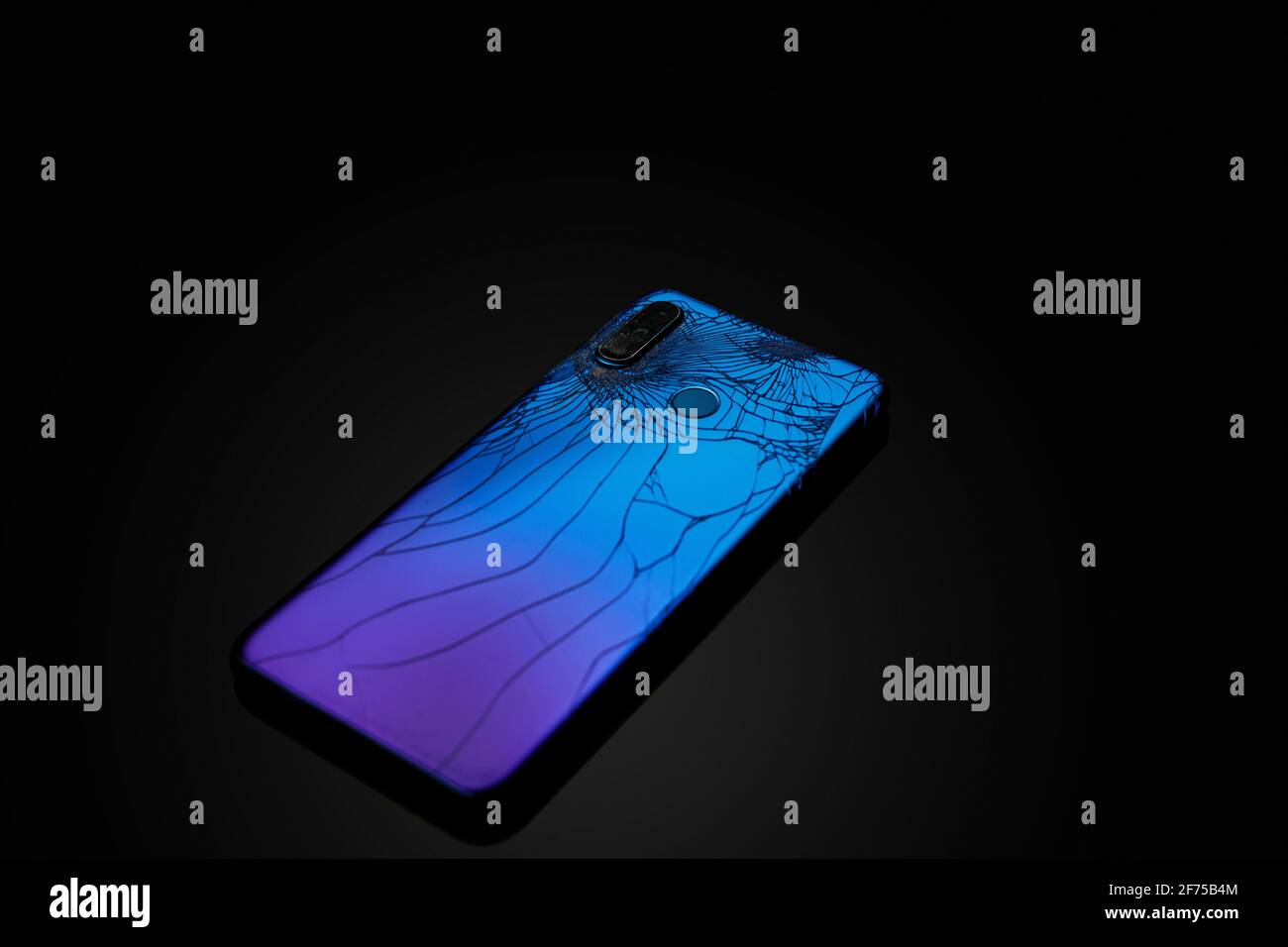 The back side of a broken phone. Spoiled smartphone camera Stock Photo ...
