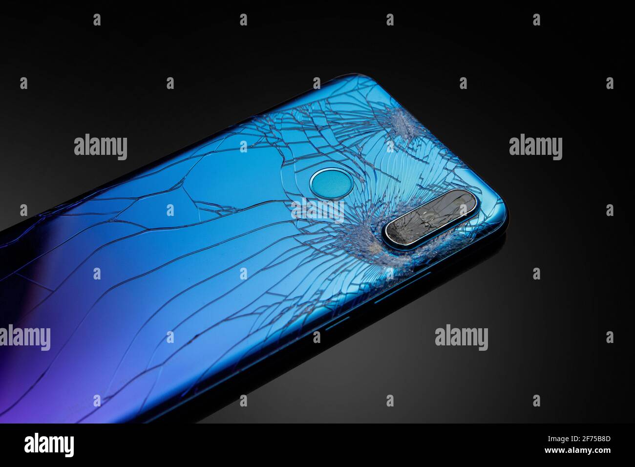 The back side of a broken phone. Spoiled smartphone camera Stock Photo ...