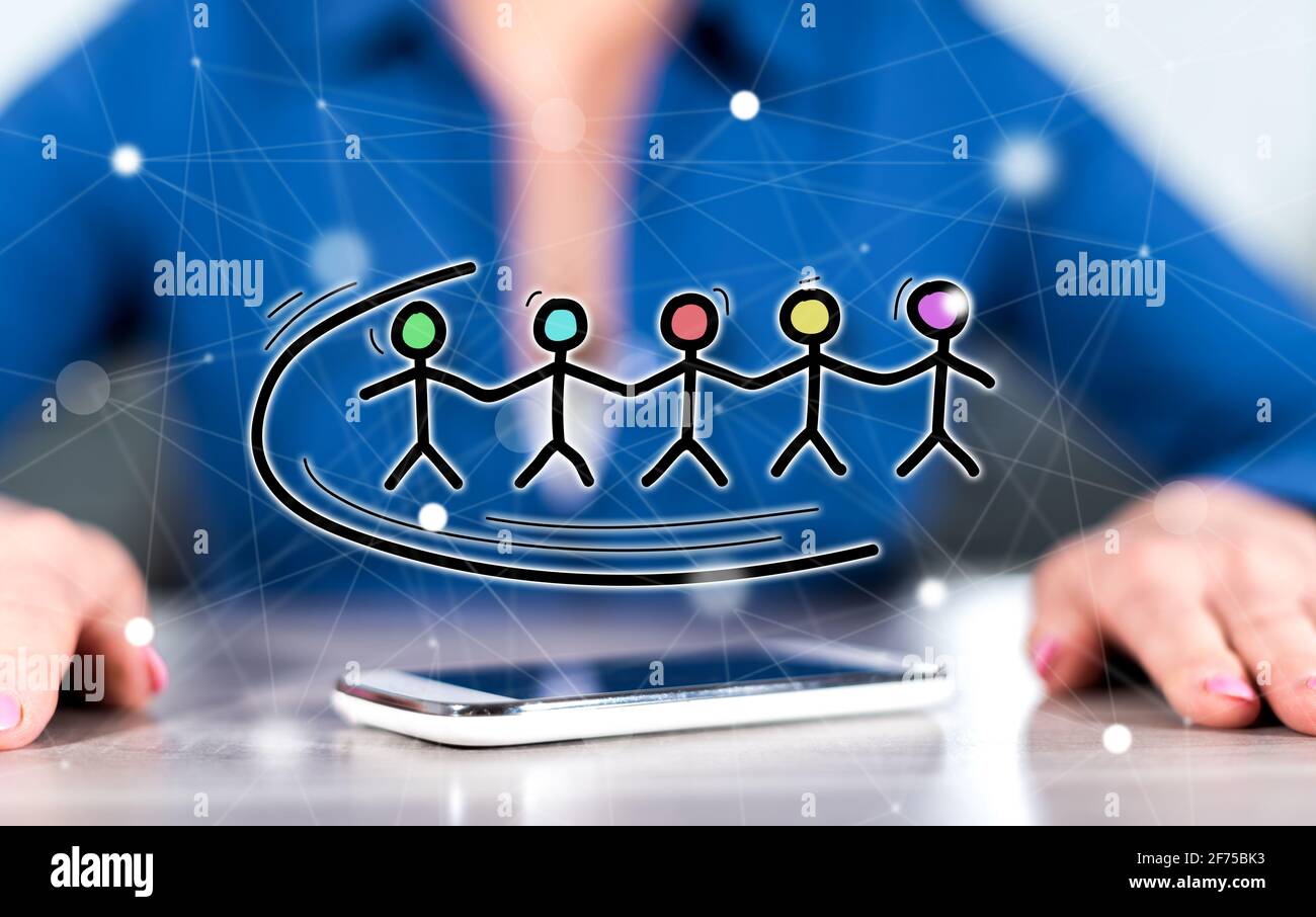 Smartphone with teamwork concept between hands of a woman in background ...