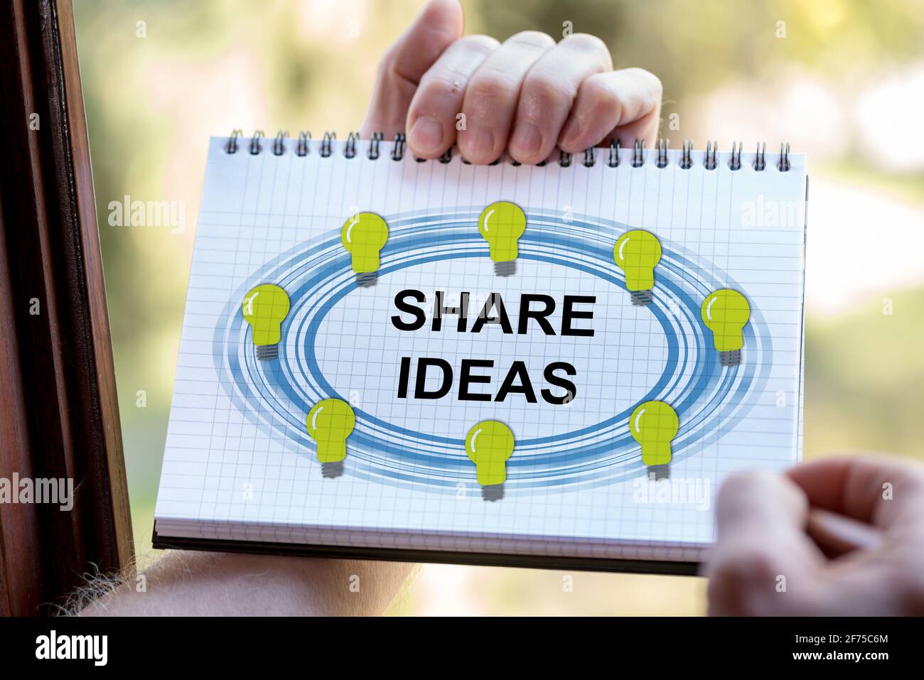 Hand drawing share ideas concept on a notepad Stock Photo - Alamy