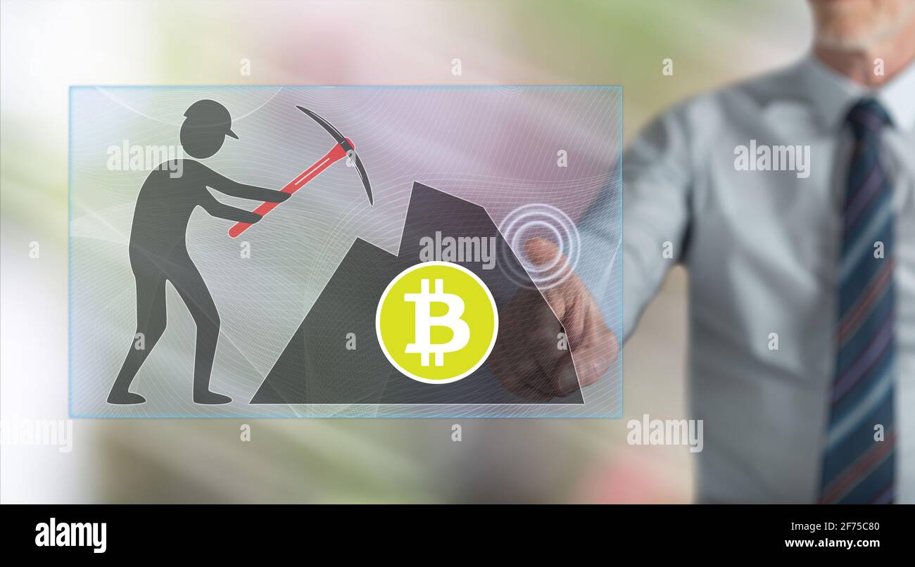 Man touching a bitcoin mining concept on a touch screen with his finger ...