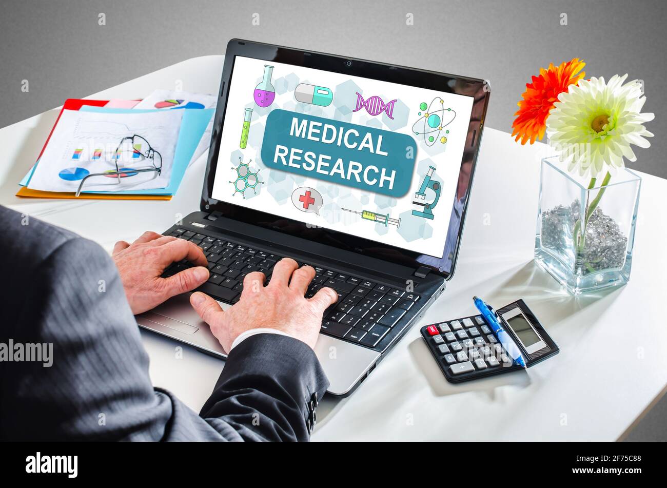 Man typing on a laptop showing a medical research concept Stock Photo ...