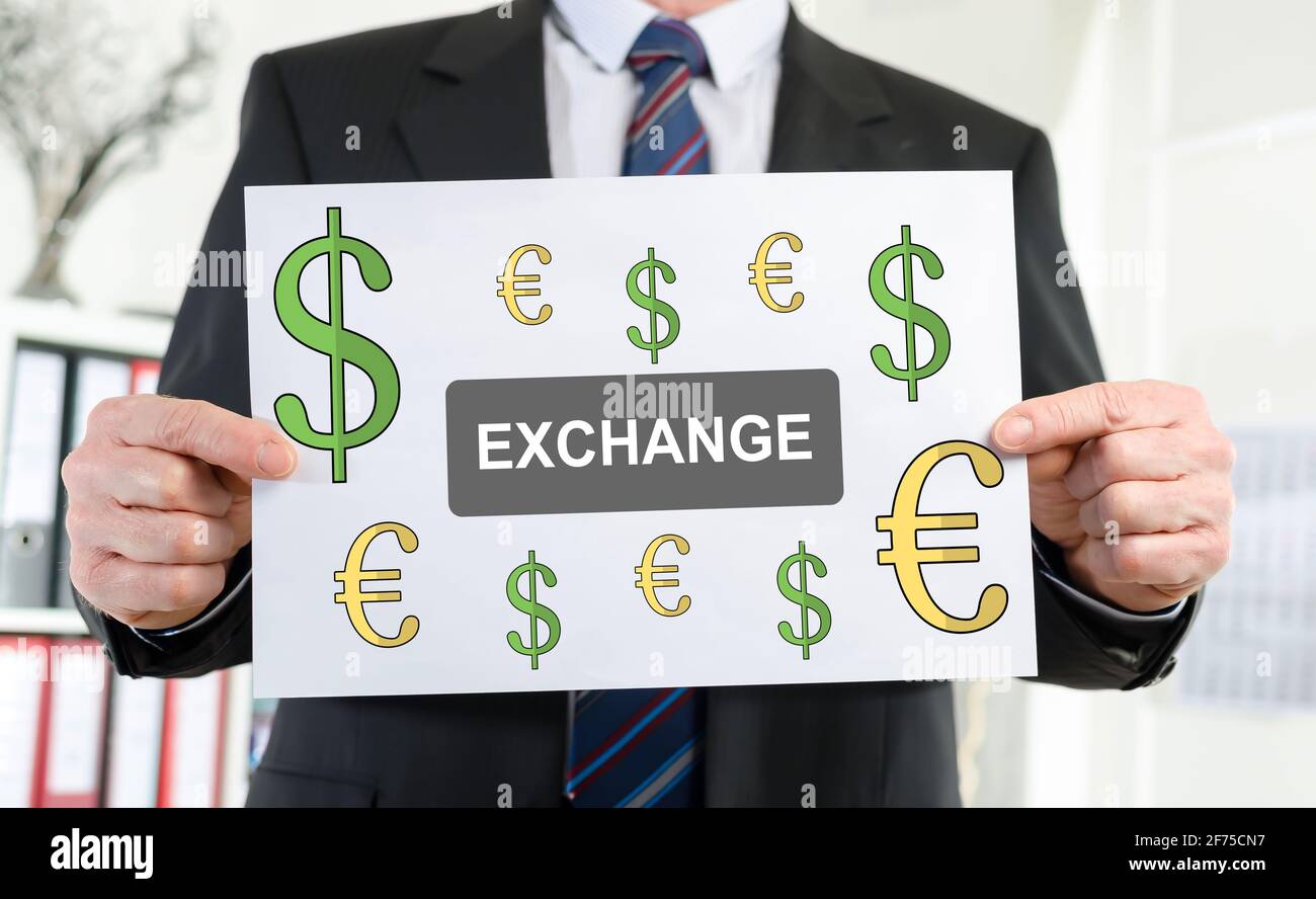 Paper showing exchange concept held by a businessman Stock Photo - Alamy