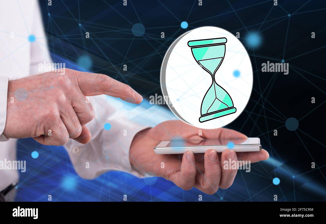Time management concept above a smartphone held by a man Stock Photo ...