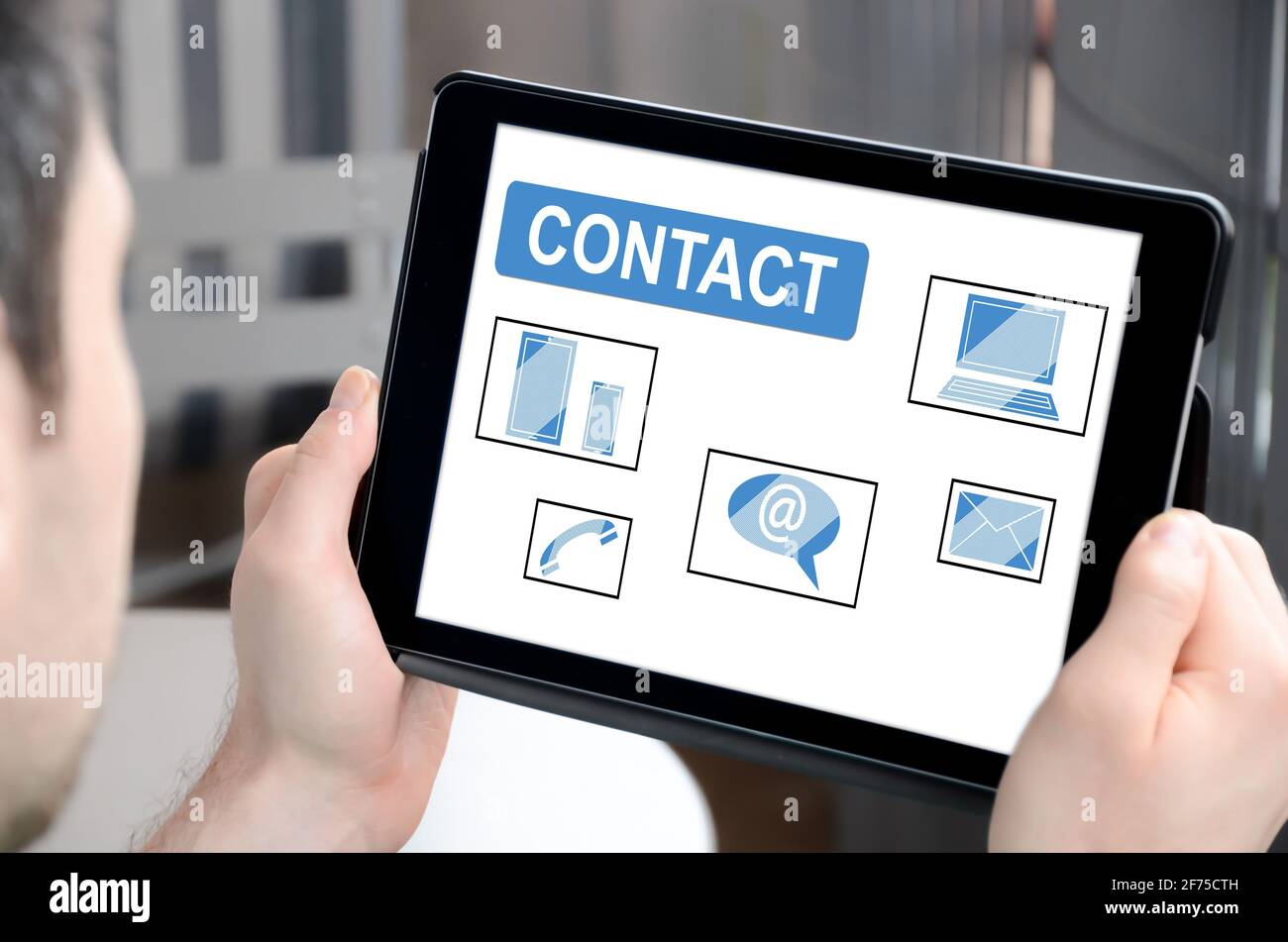 Man holding a tablet showing contact concept Stock Photo - Alamy