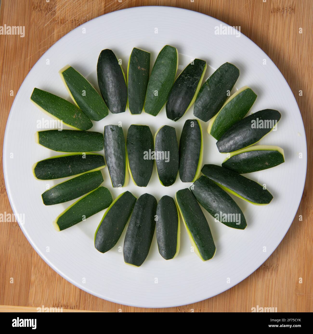 Preparing fresh courgette, zucchini on wood table Stock Photo - Alamy