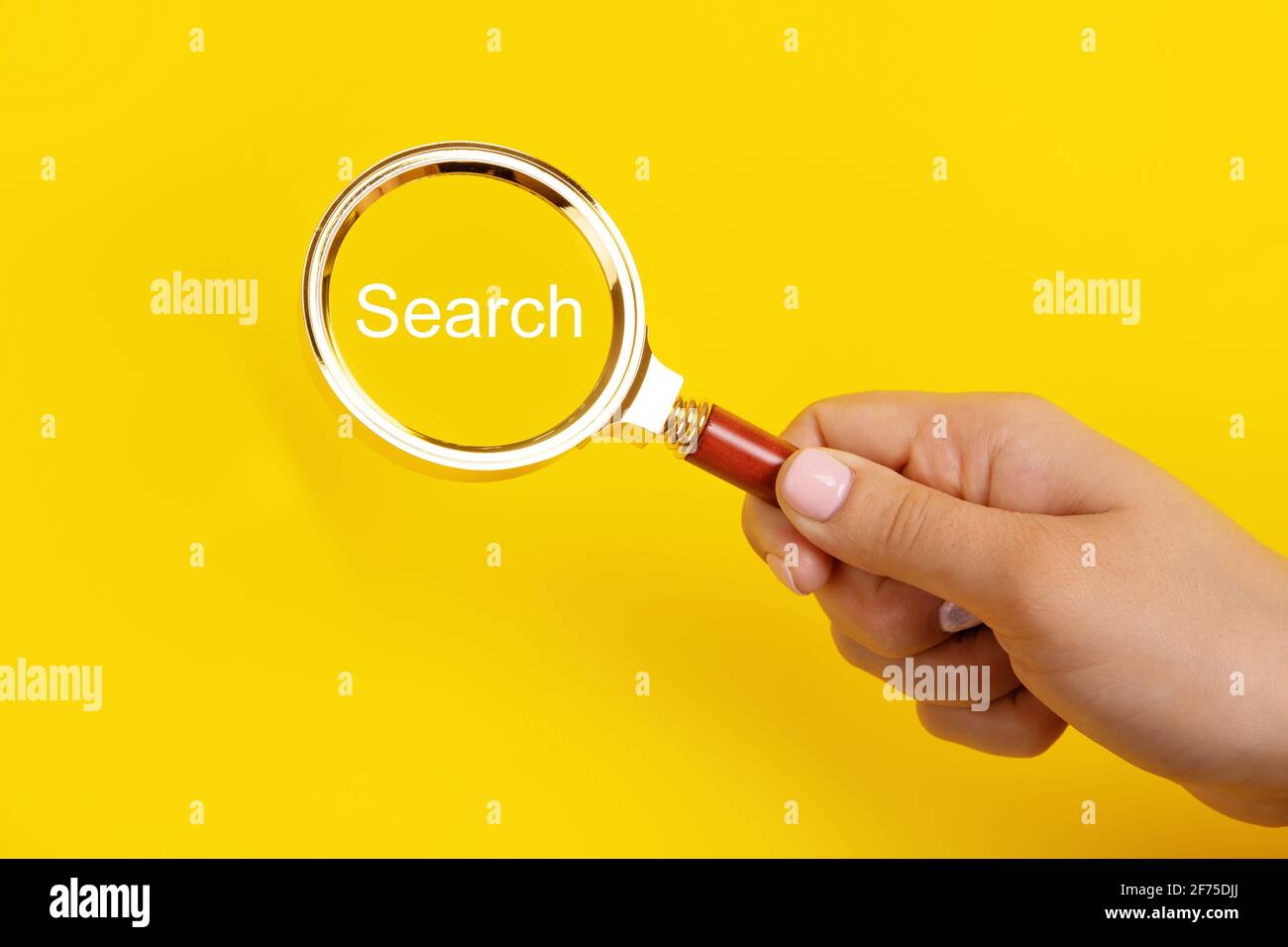 hand holding magnifier over yellow background, search concept Stock ...