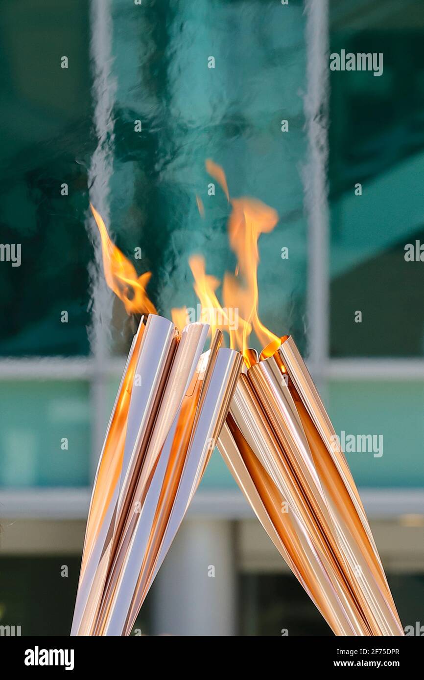 Local torchbearers pass the Olympic flame during the Tokyo 2020 Olympic ...