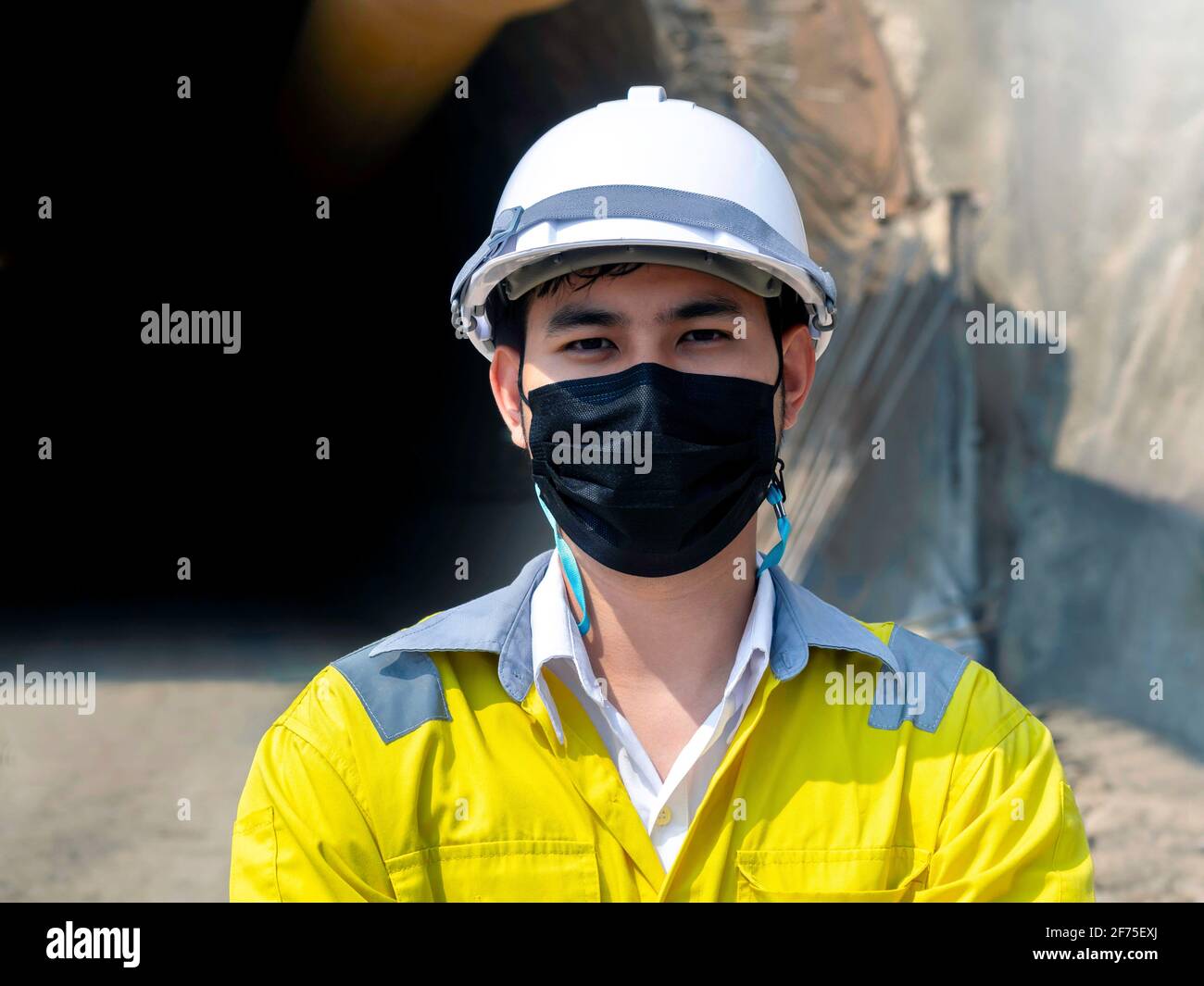 Portrait of young Asian tunnel engineering wearing high visibility ...