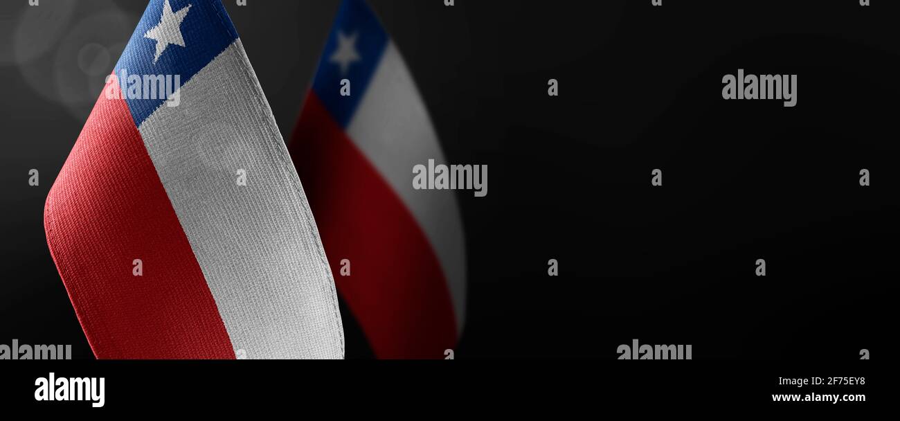 Small national flags of the Chile on a dark background Stock Photo - Alamy