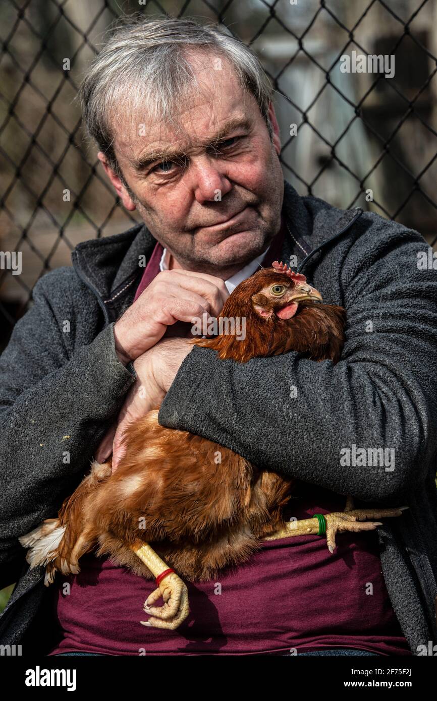man with chicken in arm Stock Photo - Alamy