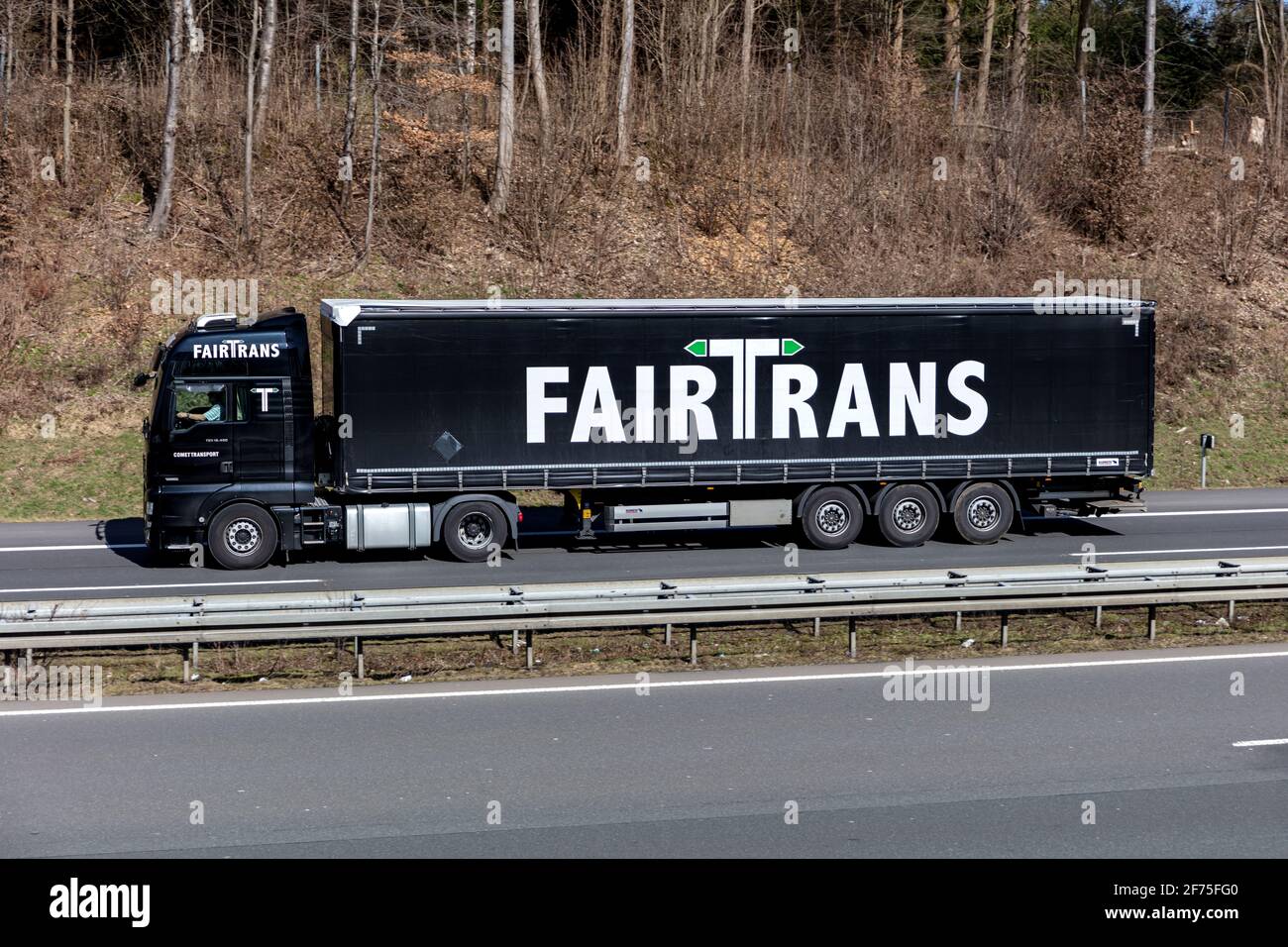 FairTrans MAN TGX truck with curtainside trailer on motorway Stock Photo - Alamy