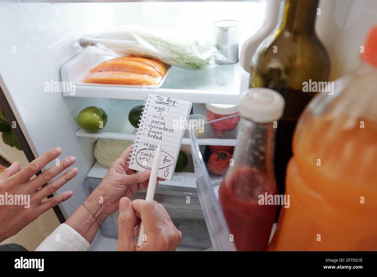 Woman fridge checking hi-res stock photography and images - Alamy