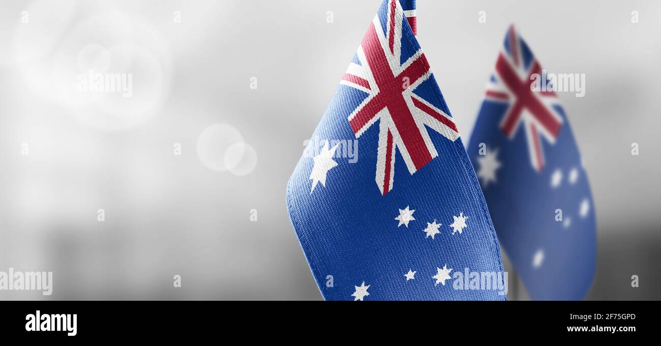 Small national flags of the Australia on a light blurry background ...