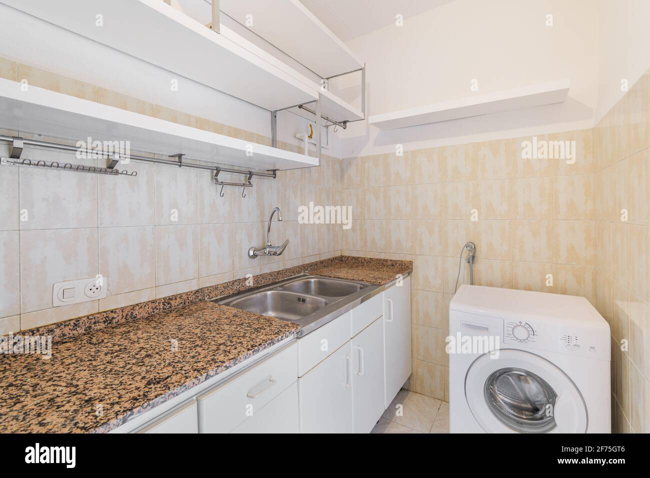 Old empty kitchen with shelves, tiled walls, marble countertop and ...