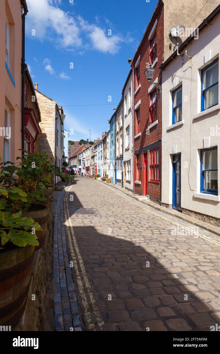 Colourful cottages along the narrow cobbled High Street in Staithes, a ...