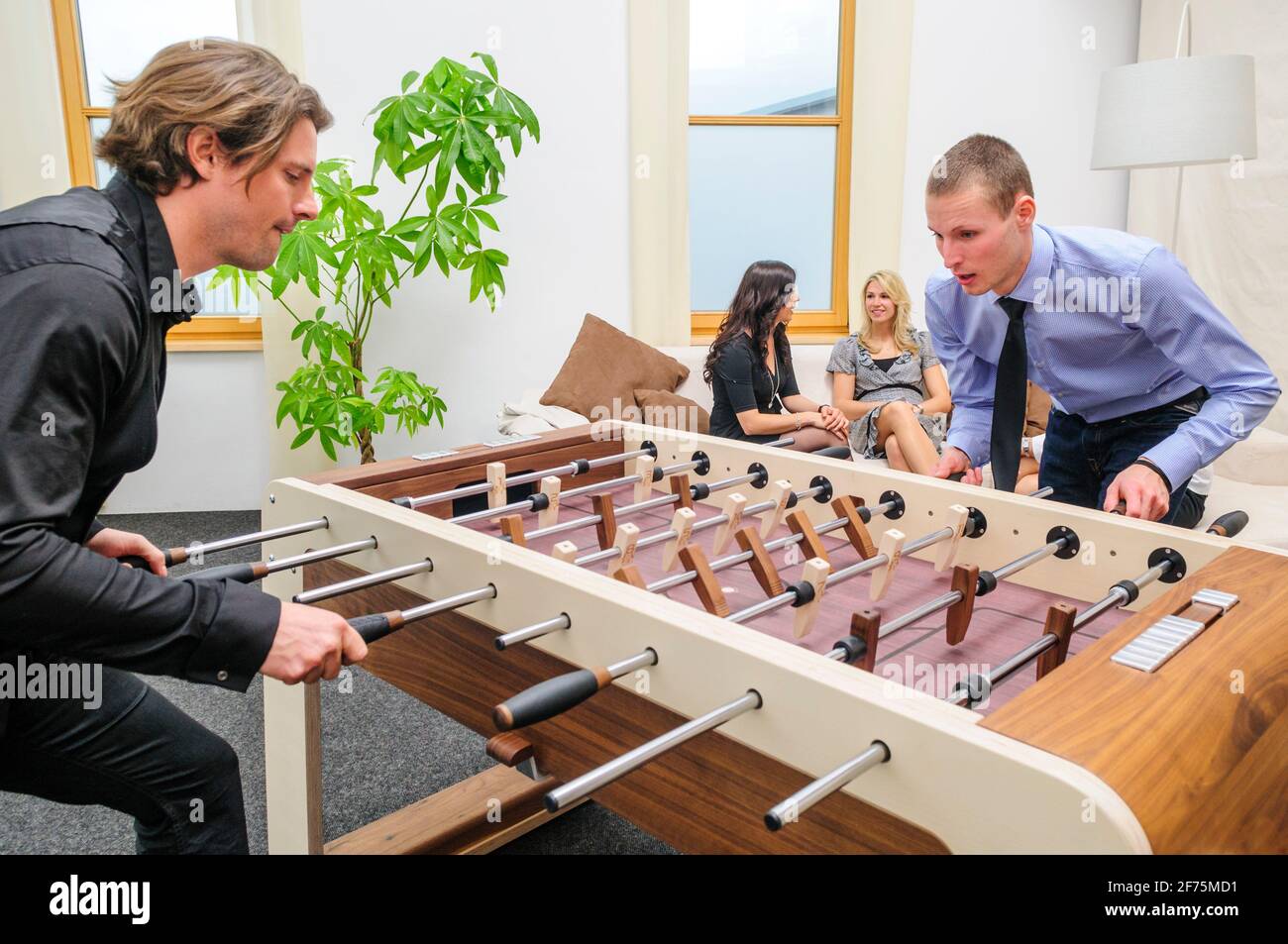 People playing table football on a wooden kicker Stock Photo - Alamy