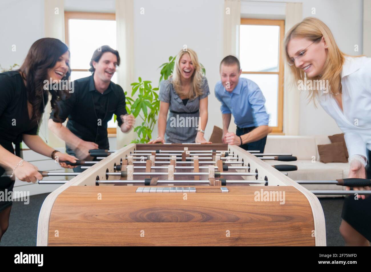 People playing table football on a wooden kicker Stock Photo - Alamy
