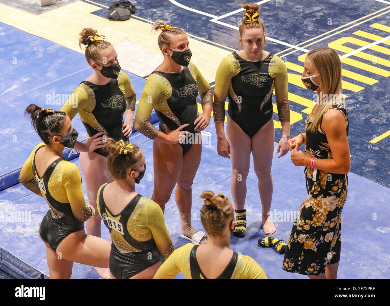 April 2, 2021: The Townson gymnastics team huddles with assistant coach ...