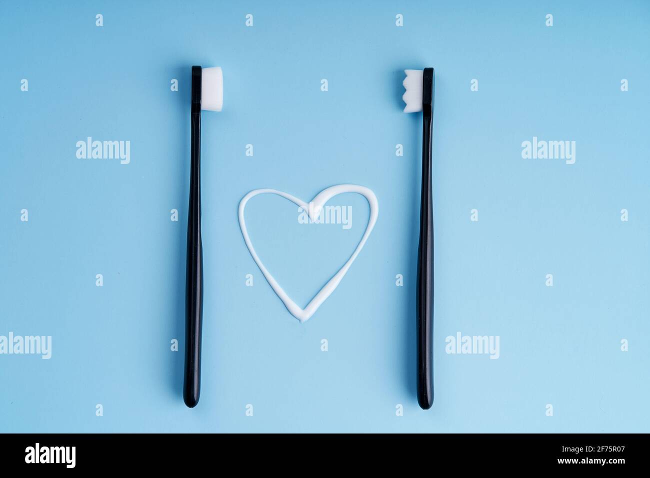 Heart shaped toothpaste between two toothbrushes Stock Photo - Alamy