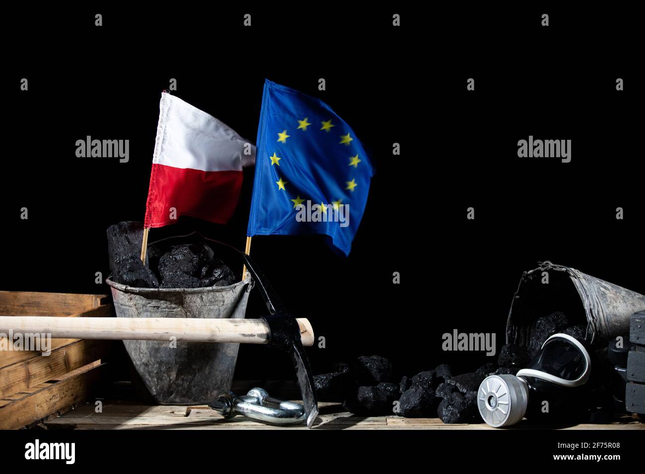 In a bucket full of black coal the flags of the European Union and ...