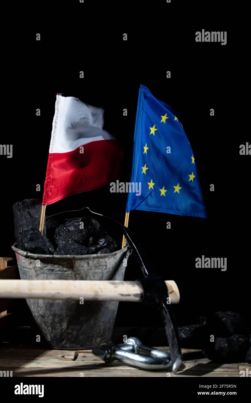 In a bucket full of black coal the flags of the European Union and ...