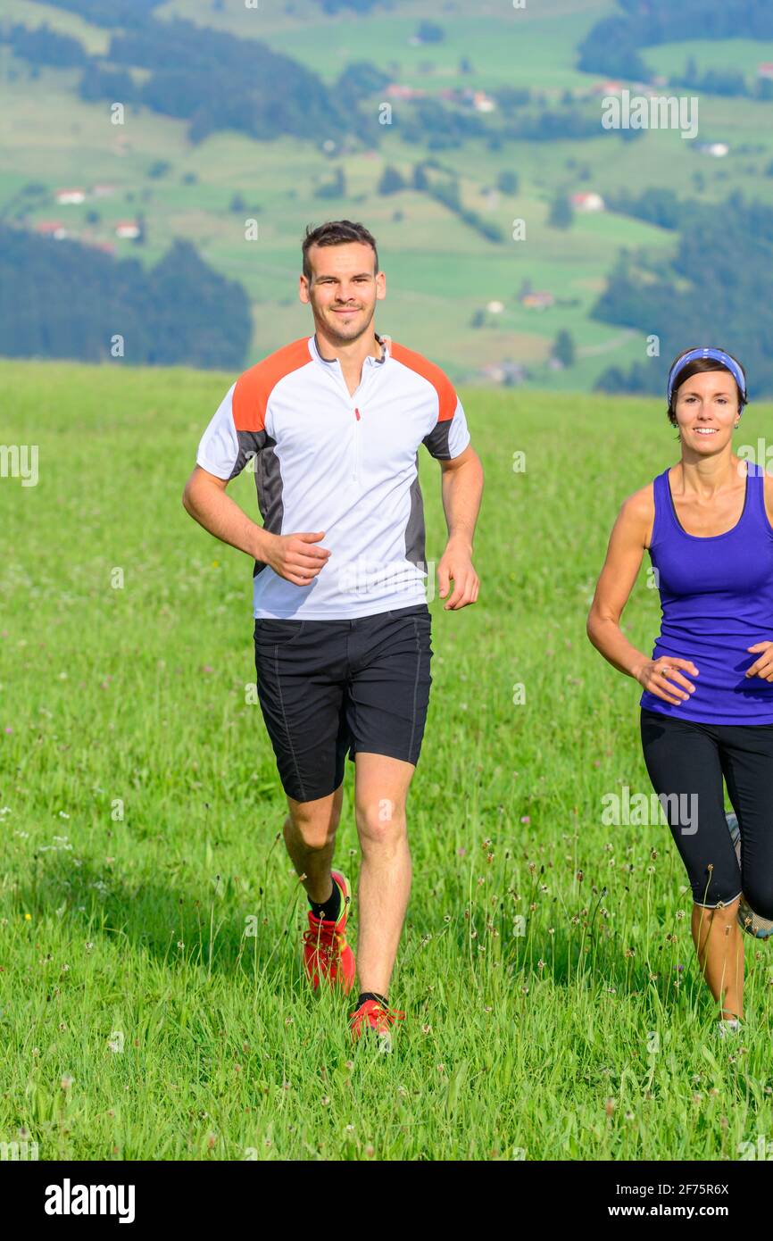 Young people jogging on a forest path, joint-friendly running training ...