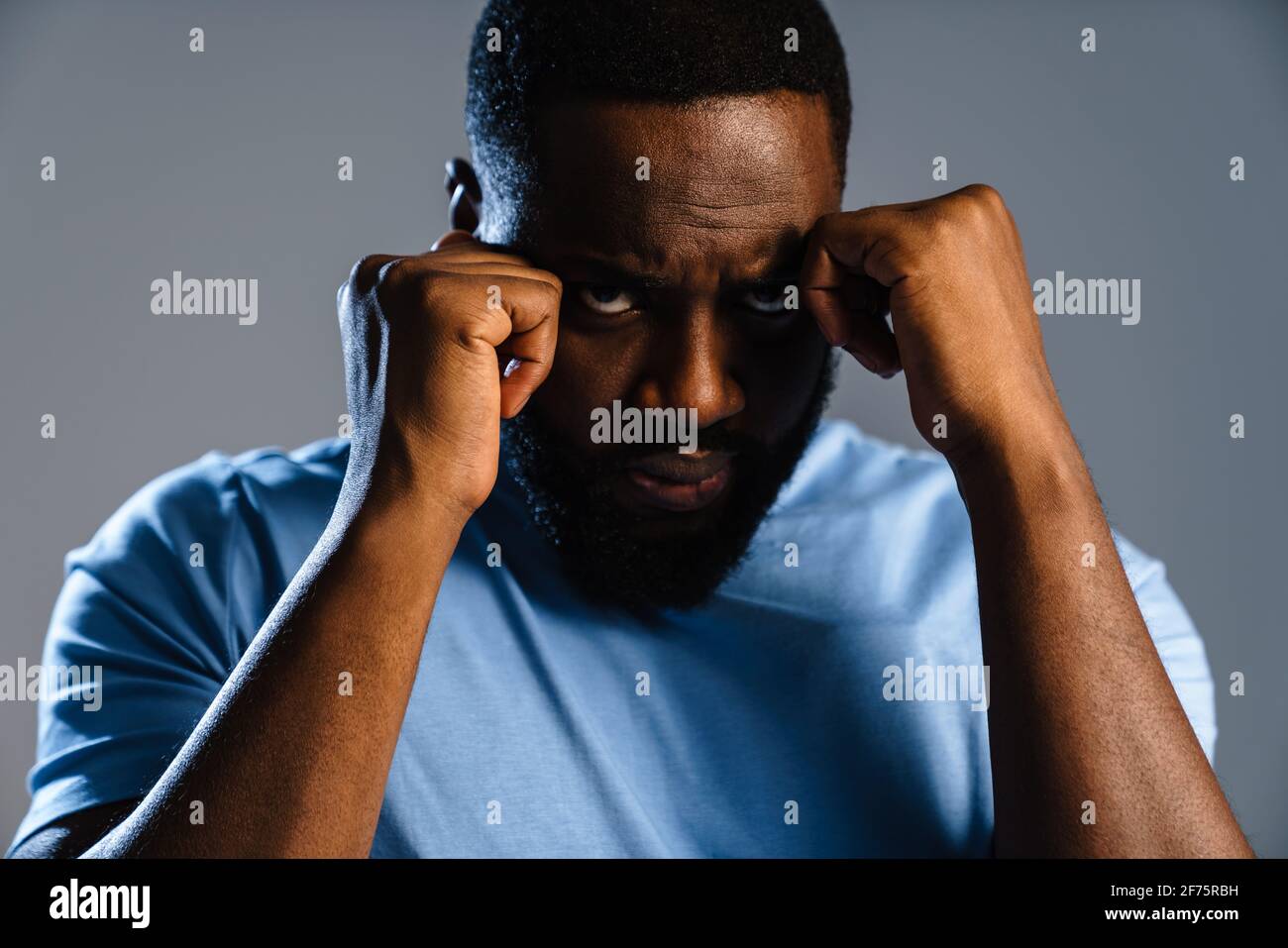 Confident african sportsman during boxing training isolated over gray ...