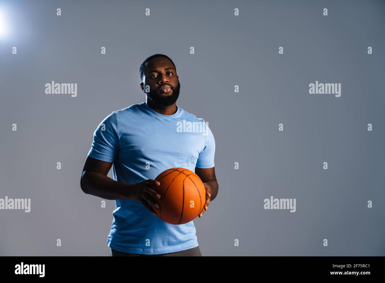 Young african basketball player with basketball during game isolated ...