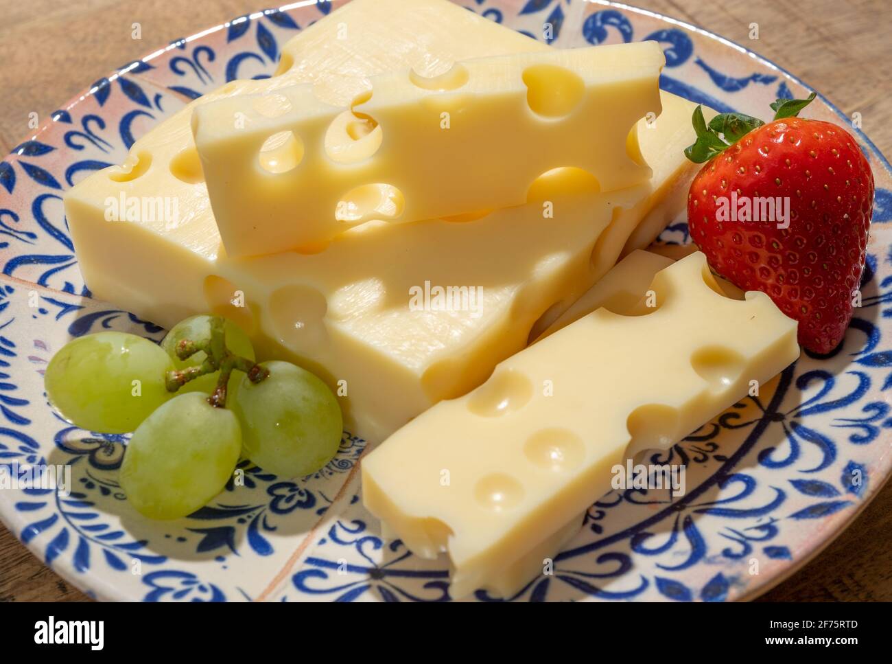 Cheese collection, blocks of French emmentaler cheese with many round ...