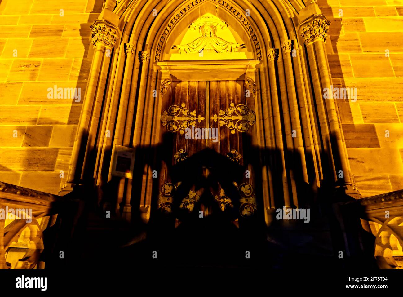 A beautiful dramatic image of a door with a shadow in the catholic ...