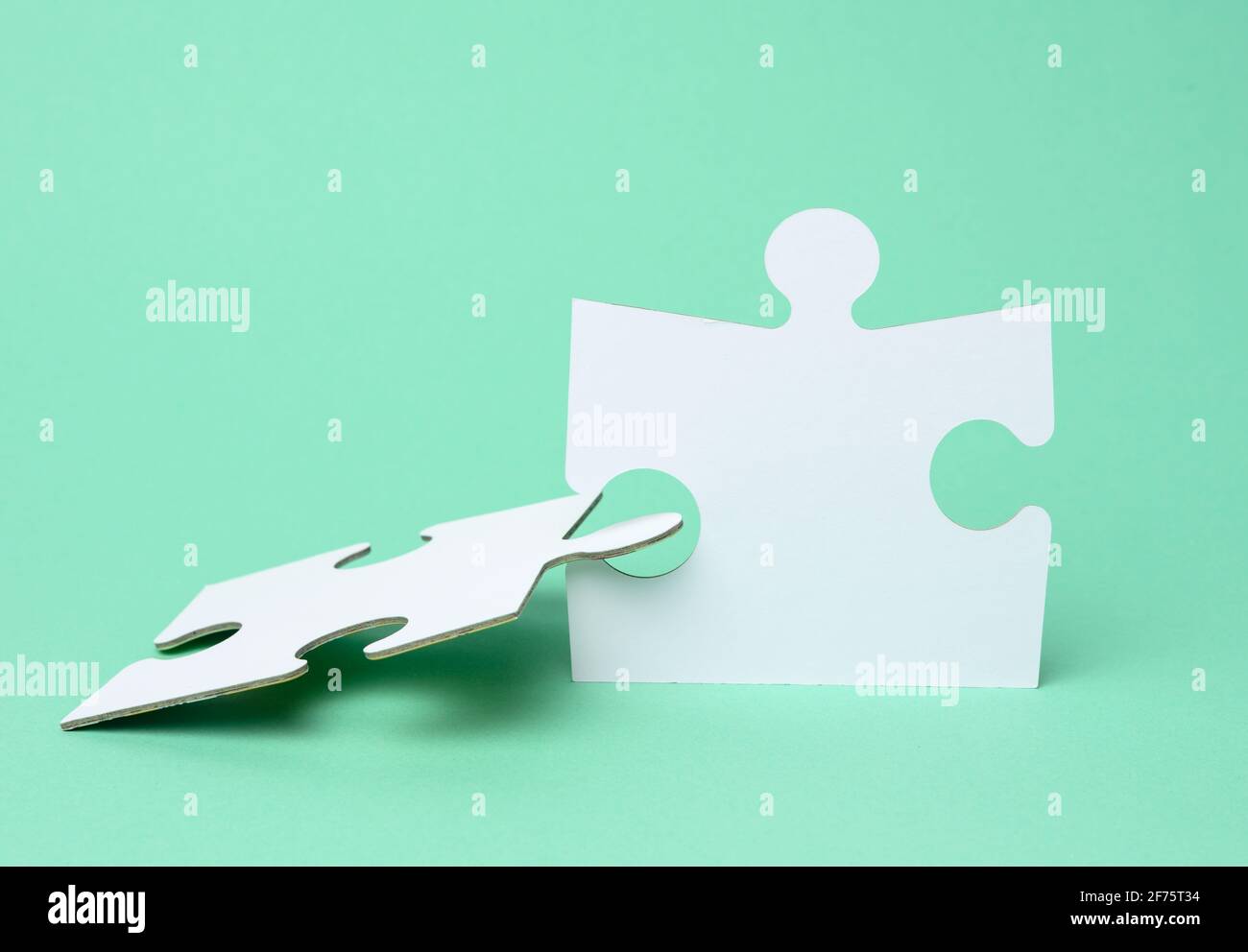 white paper puzzles on a green background, connection, close up Stock ...